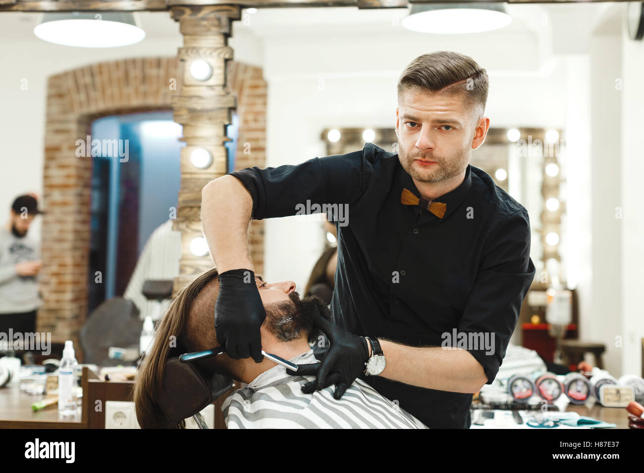 Barber making beard form for man Stock Photo - Alamy