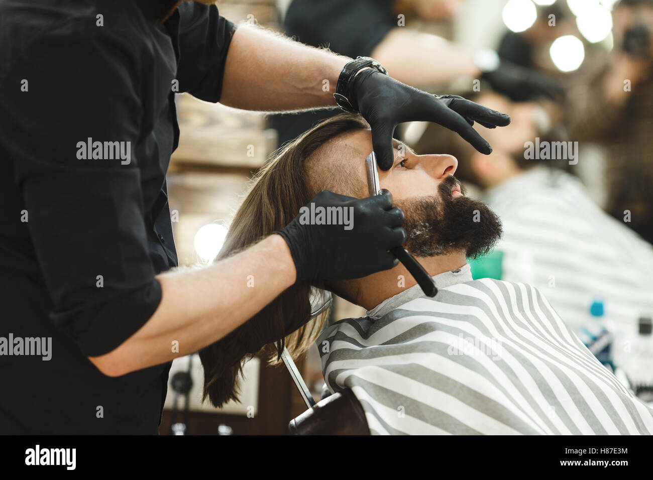 Hands in gloves making beard form Stock Photo - Alamy