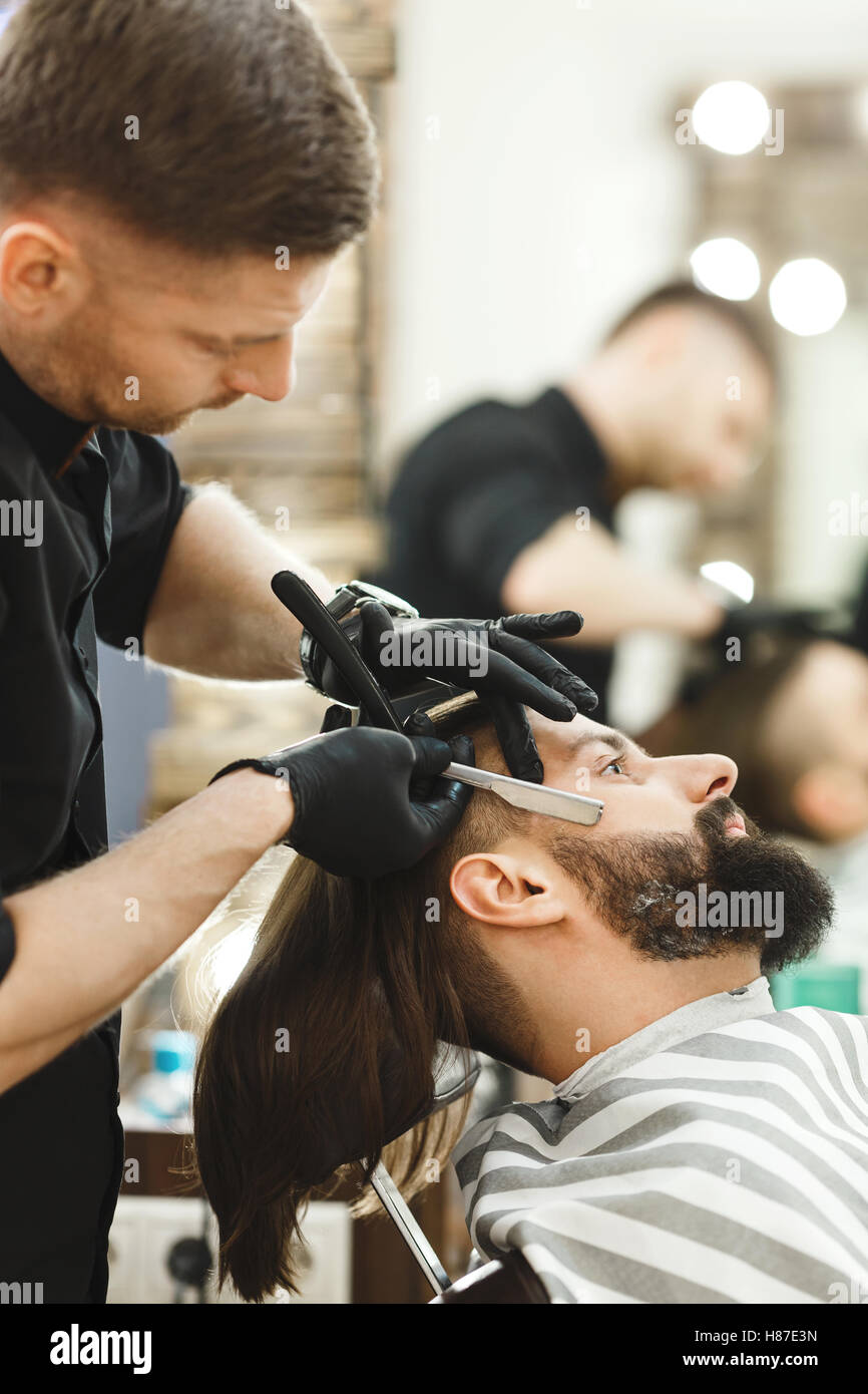Barber making beard form for man Stock Photo - Alamy