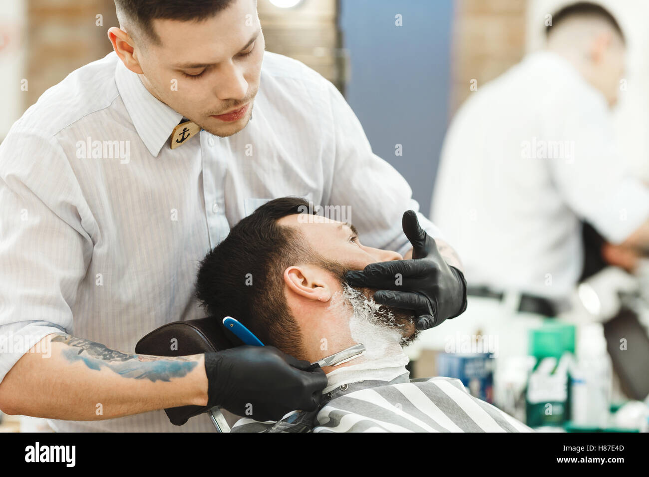 Barber making beard form for man Stock Photo - Alamy