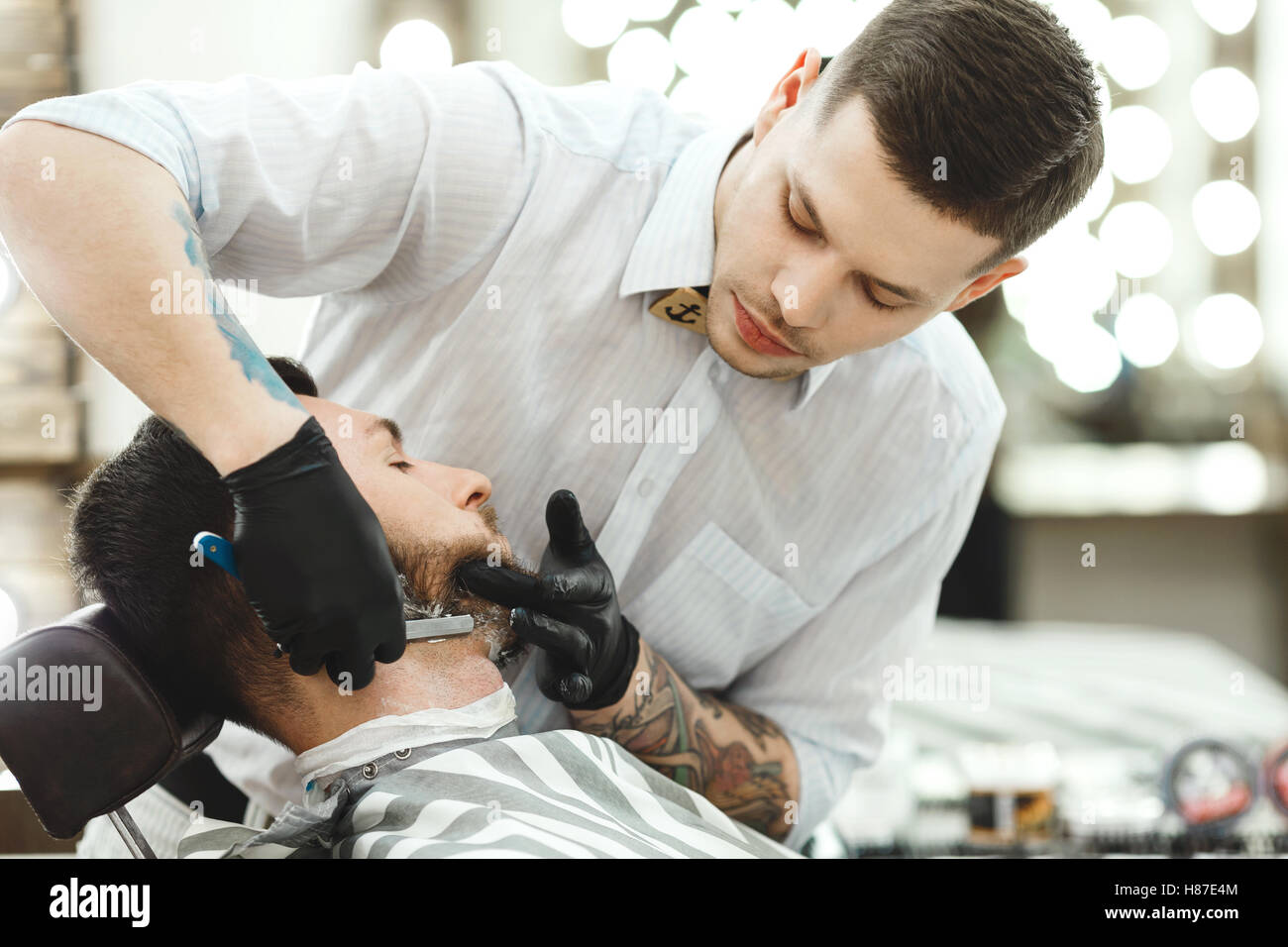 Barber making beard form for man Stock Photo - Alamy