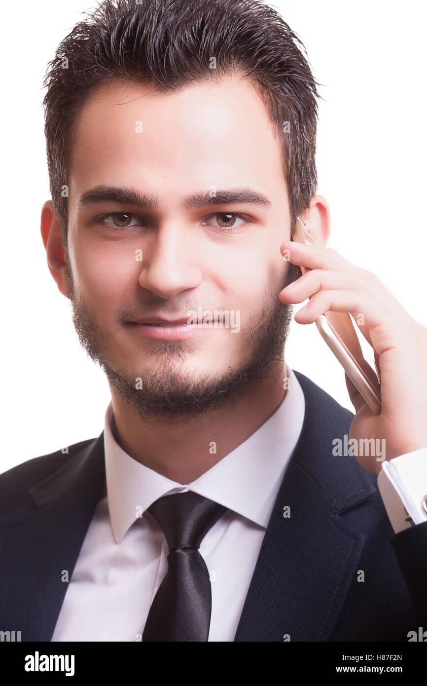 CEO of a company in suit talking to the phone on white background in ...