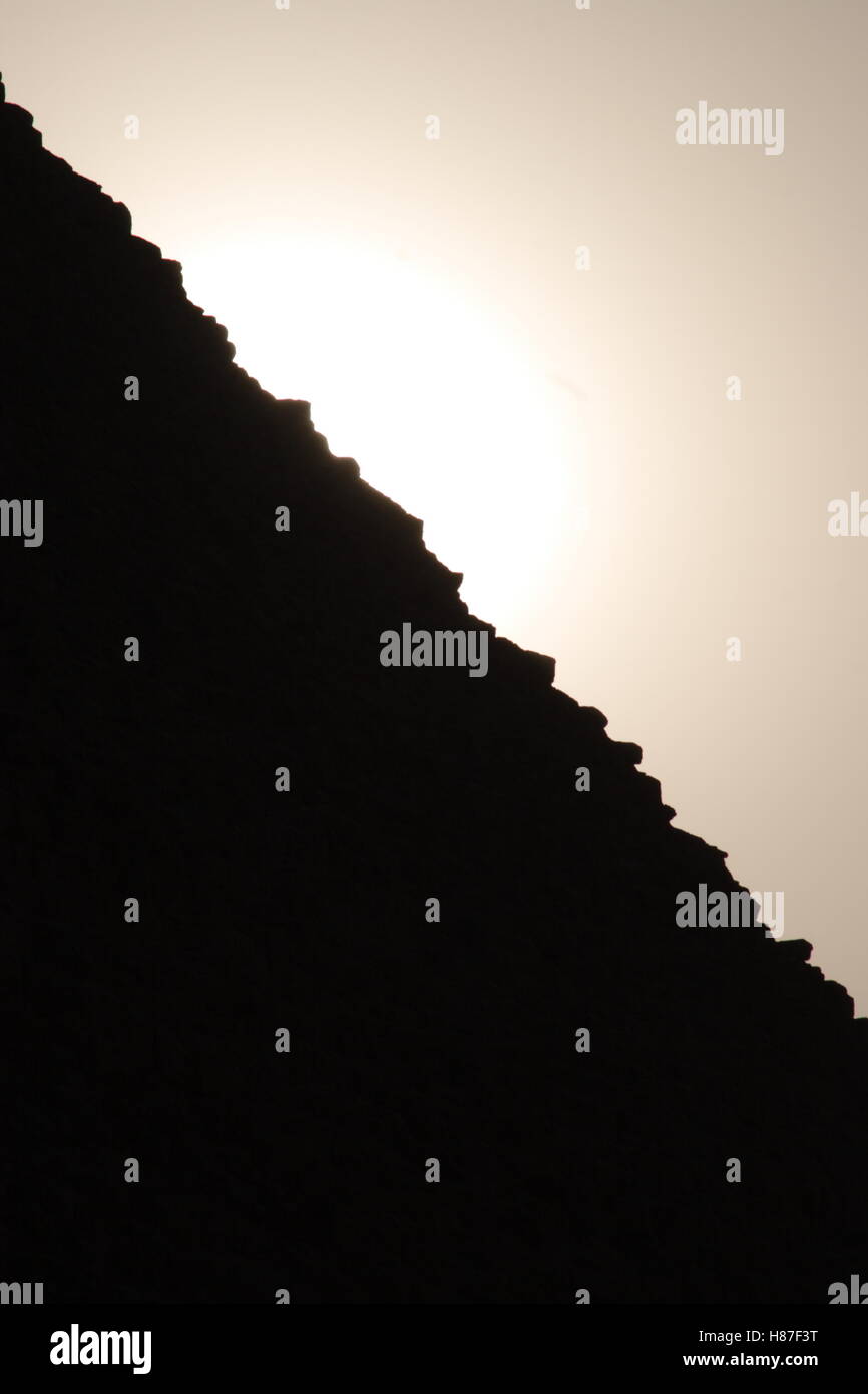 The Sun behind the pyramid Stock Photo - Alamy