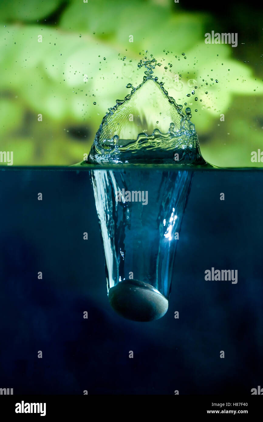 A rock splashing into water. Photographed with a high-speed camera ...