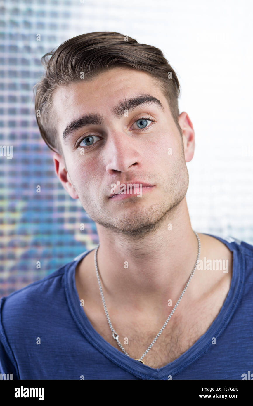 Young man in studio looking at camera Stock Photo - Alamy