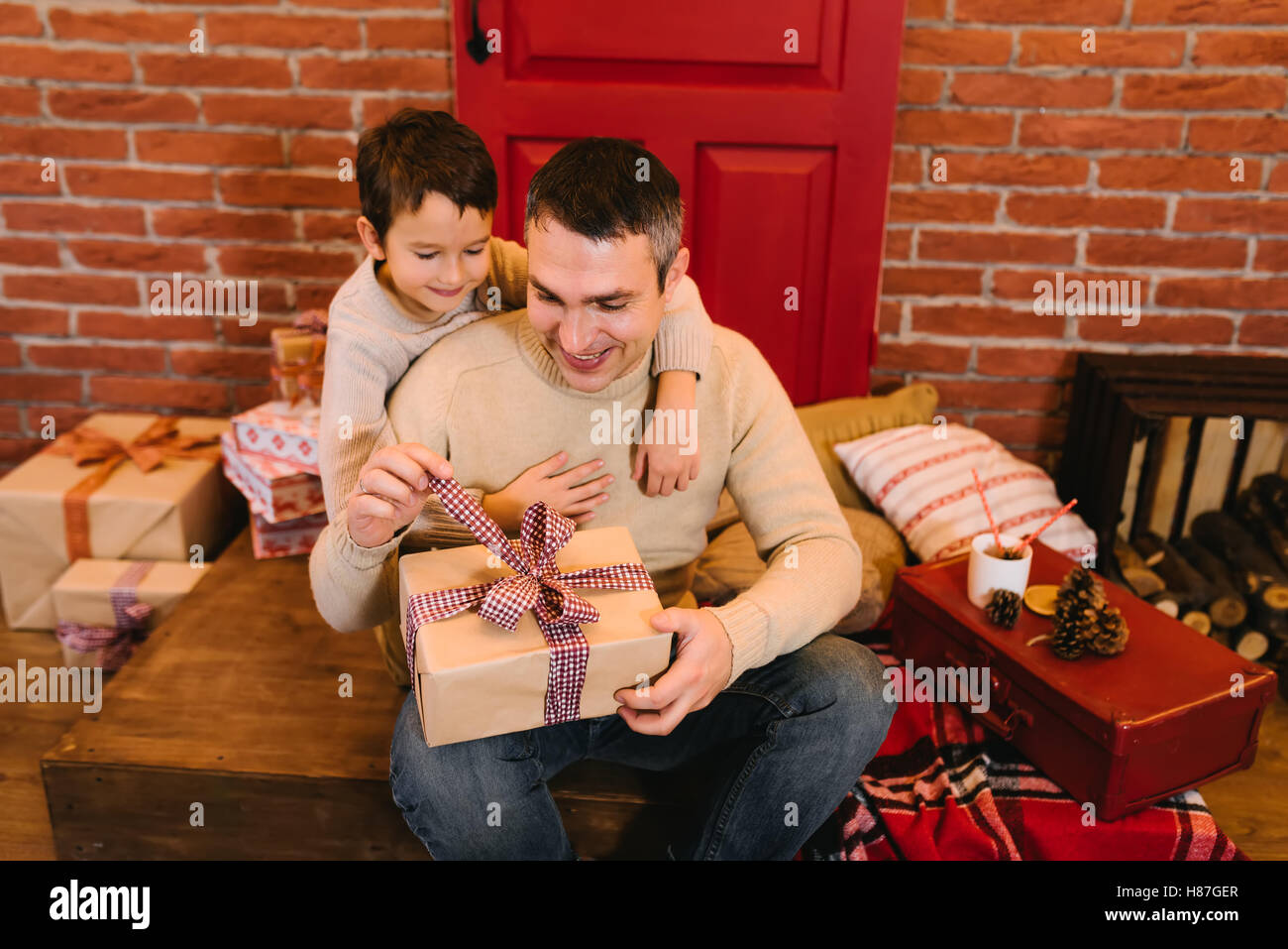The father gives his son a gift for Christmas Stock Photo - Alamy