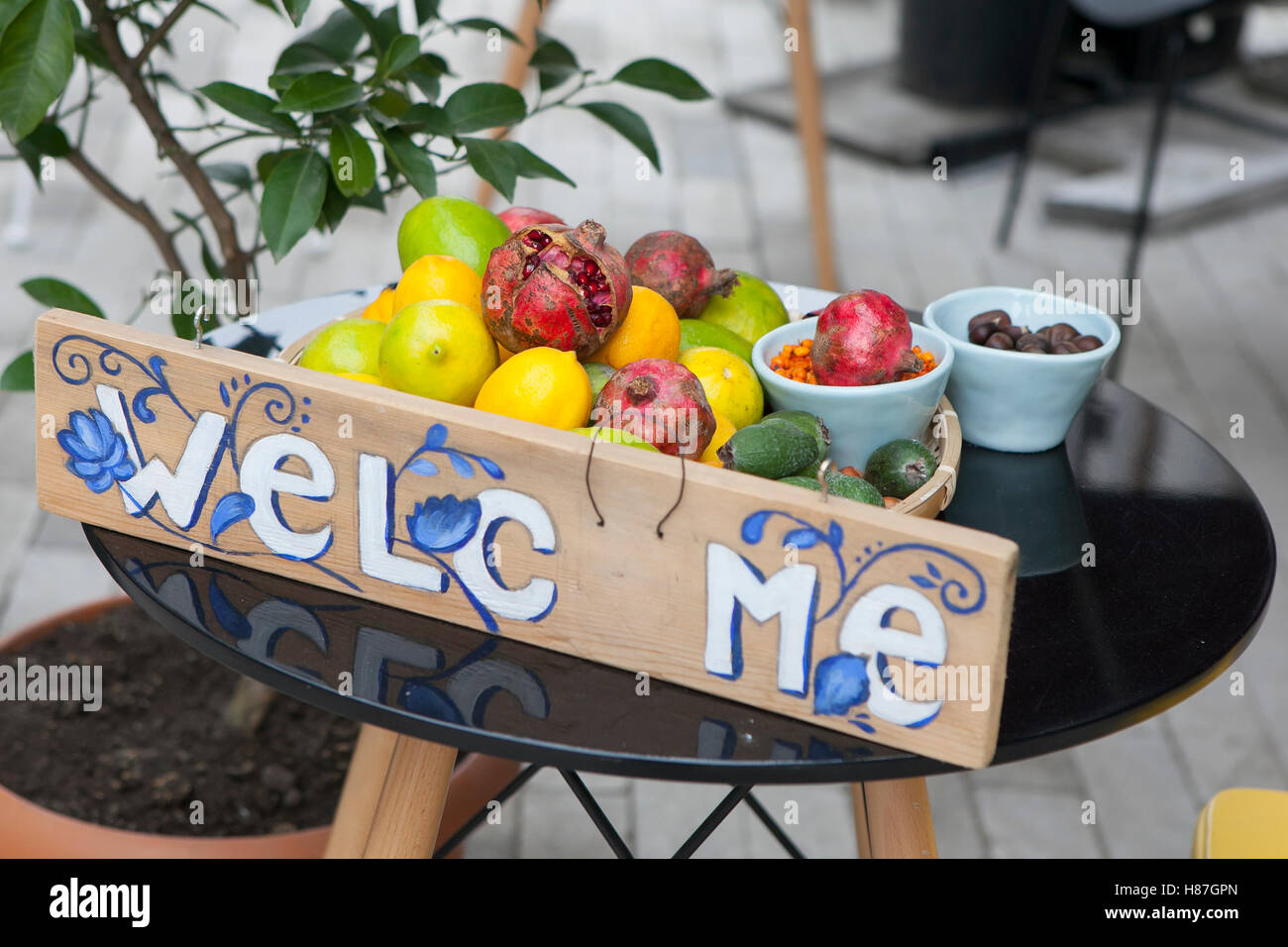 fruit on the shop entrance with a sign "welcome" without the letter O ...