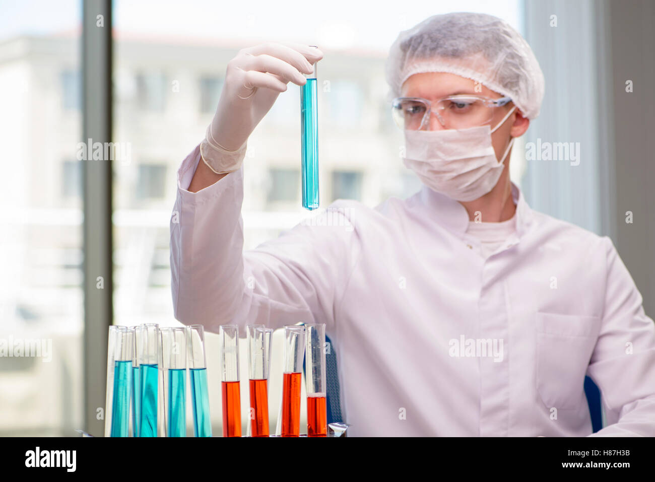Man working in the chemical lab on science project Stock Photo - Alamy