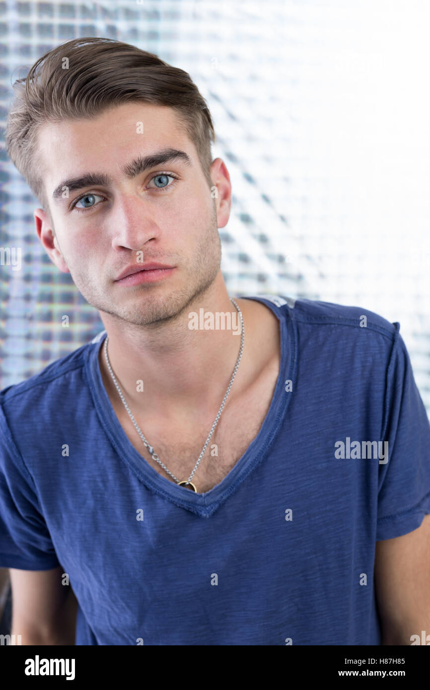 Young man in studio looking at camera Stock Photo - Alamy