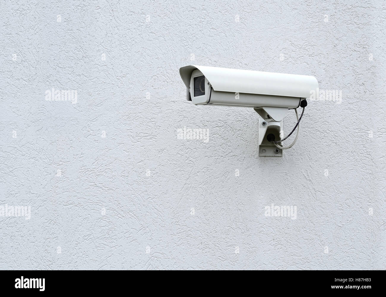 CCTV security camera on a gray the wall Stock Photo - Alamy