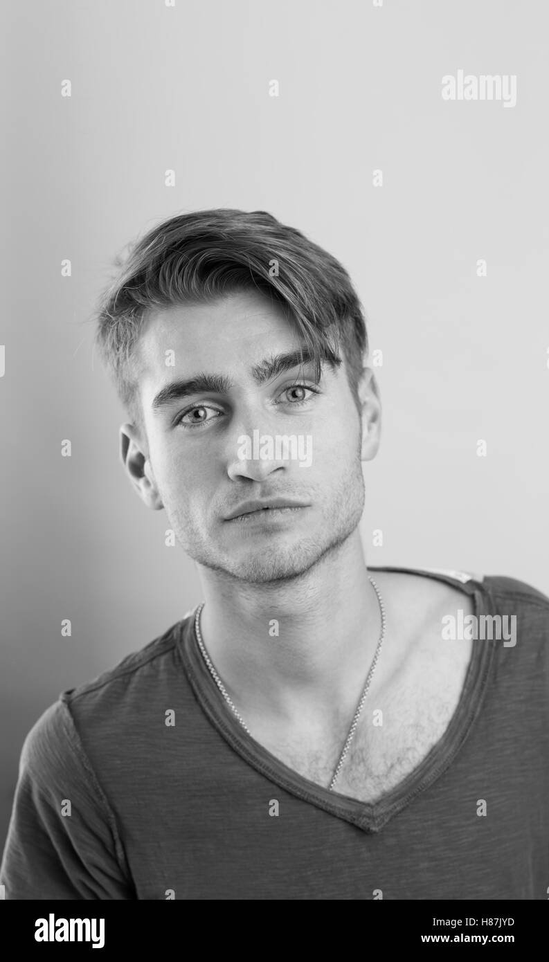 Portrait of young man on gray background Stock Photo - Alamy