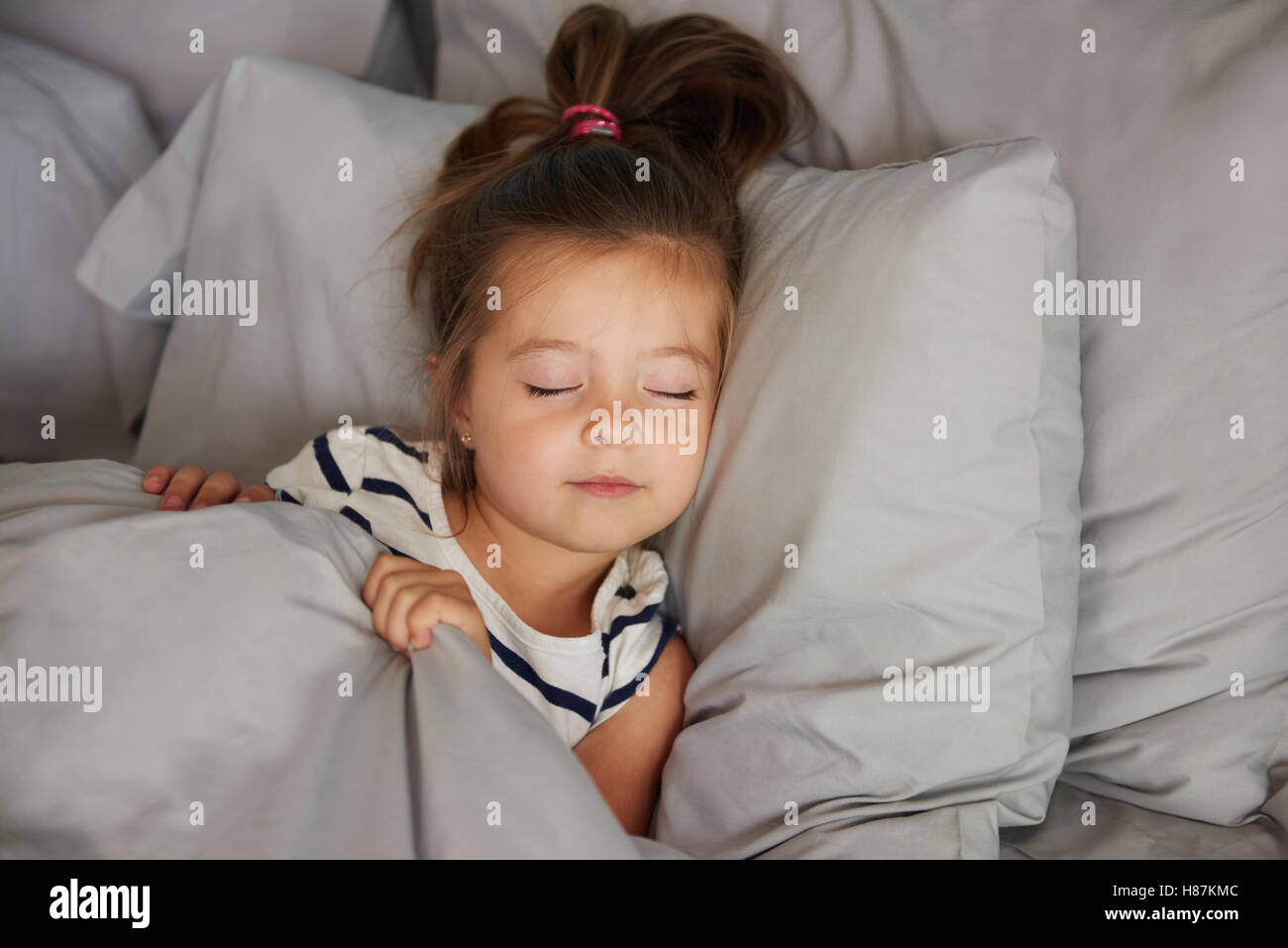 Blonde girl lying in bed hi-res stock photography and images - Alamy