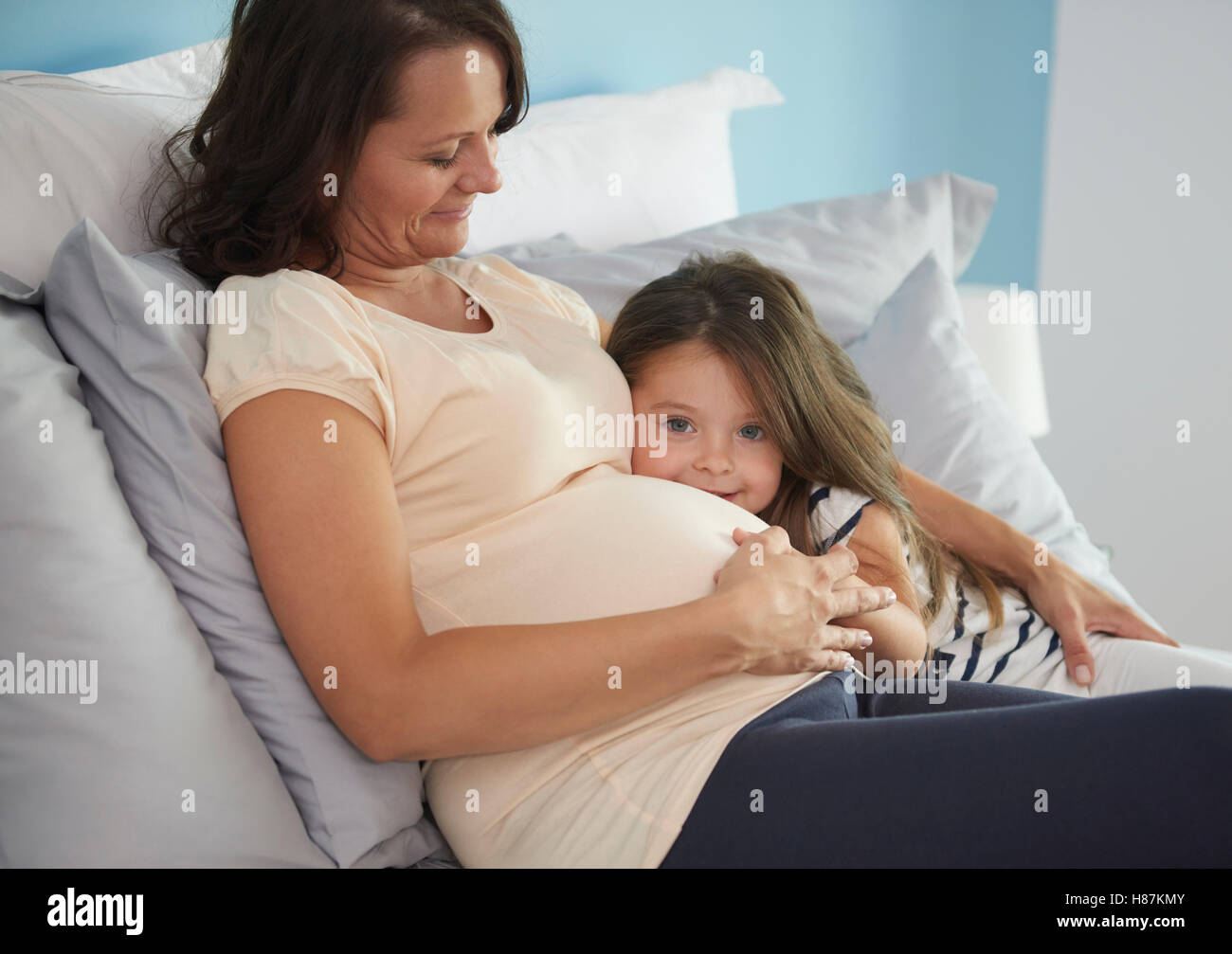 Daughter and mom resting in the bed Stock Photo - Alamy