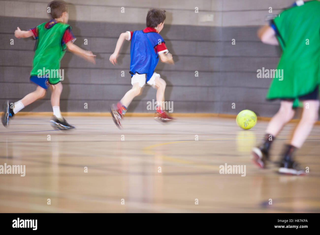 Boys playing indoor football Stock Photo - Alamy
