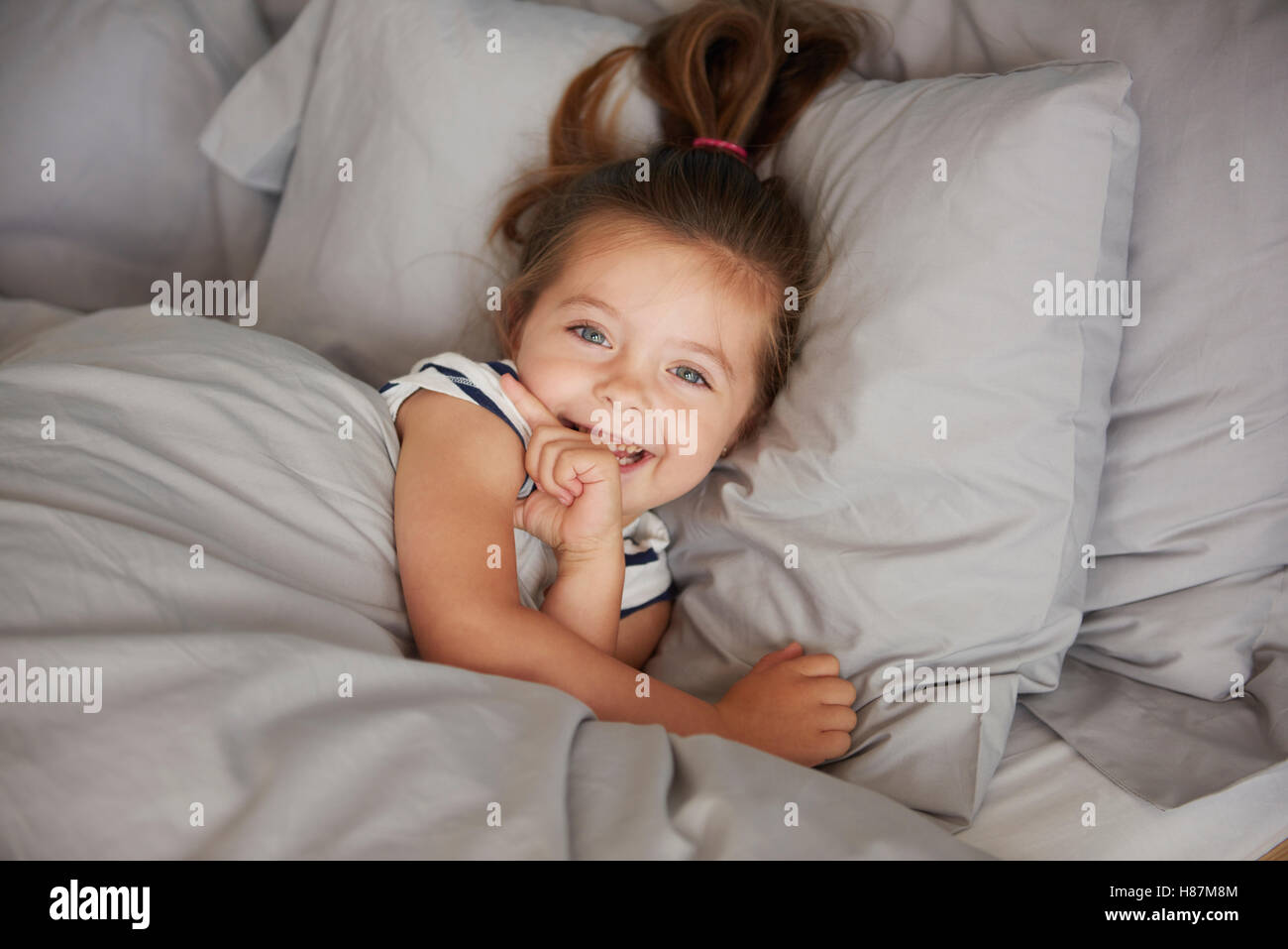 Baby girl had a proper rest in bed Stock Photo - Alamy
