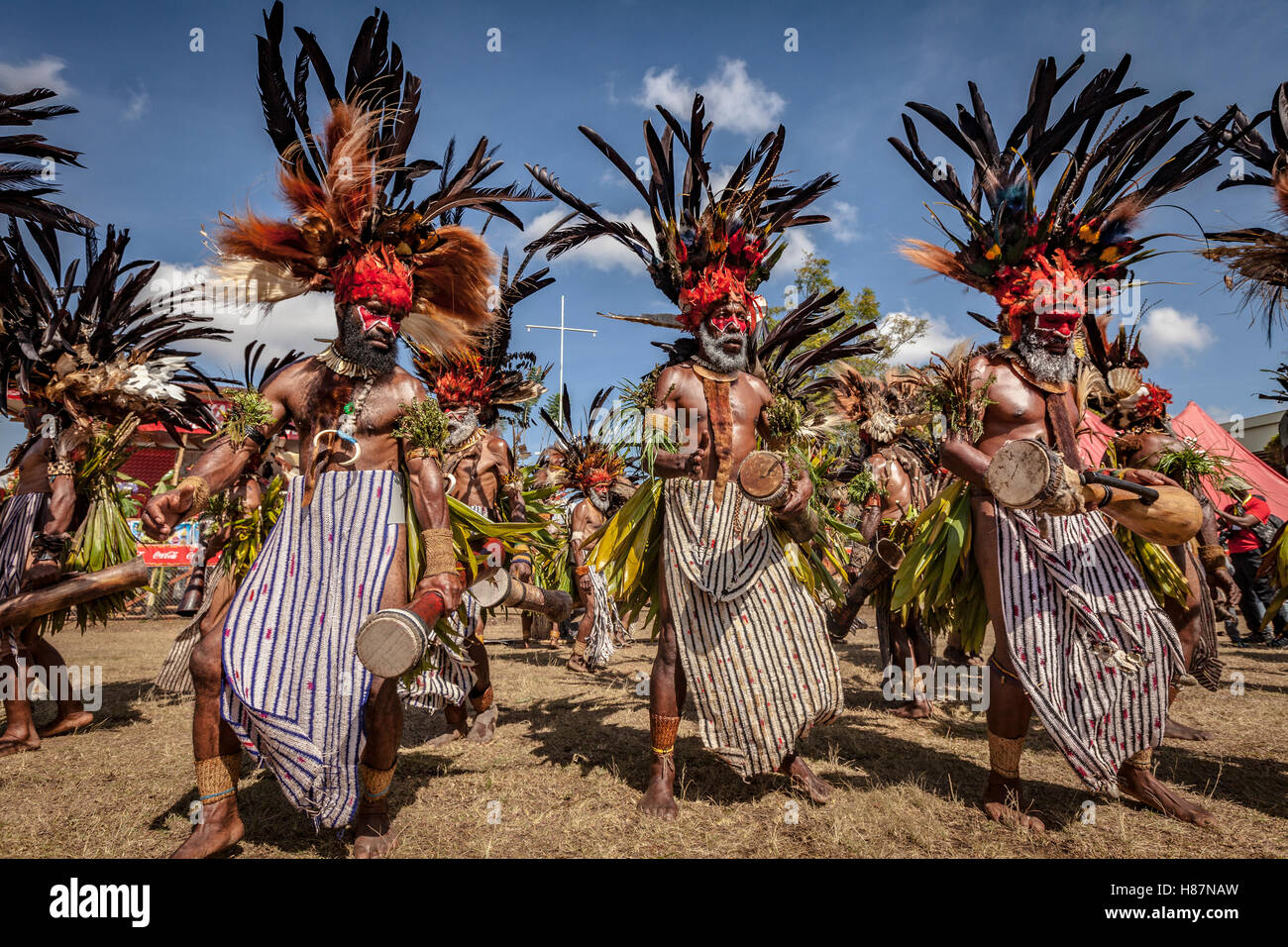 Men in ritual make-up and traditional clothing dancing during a sing ...