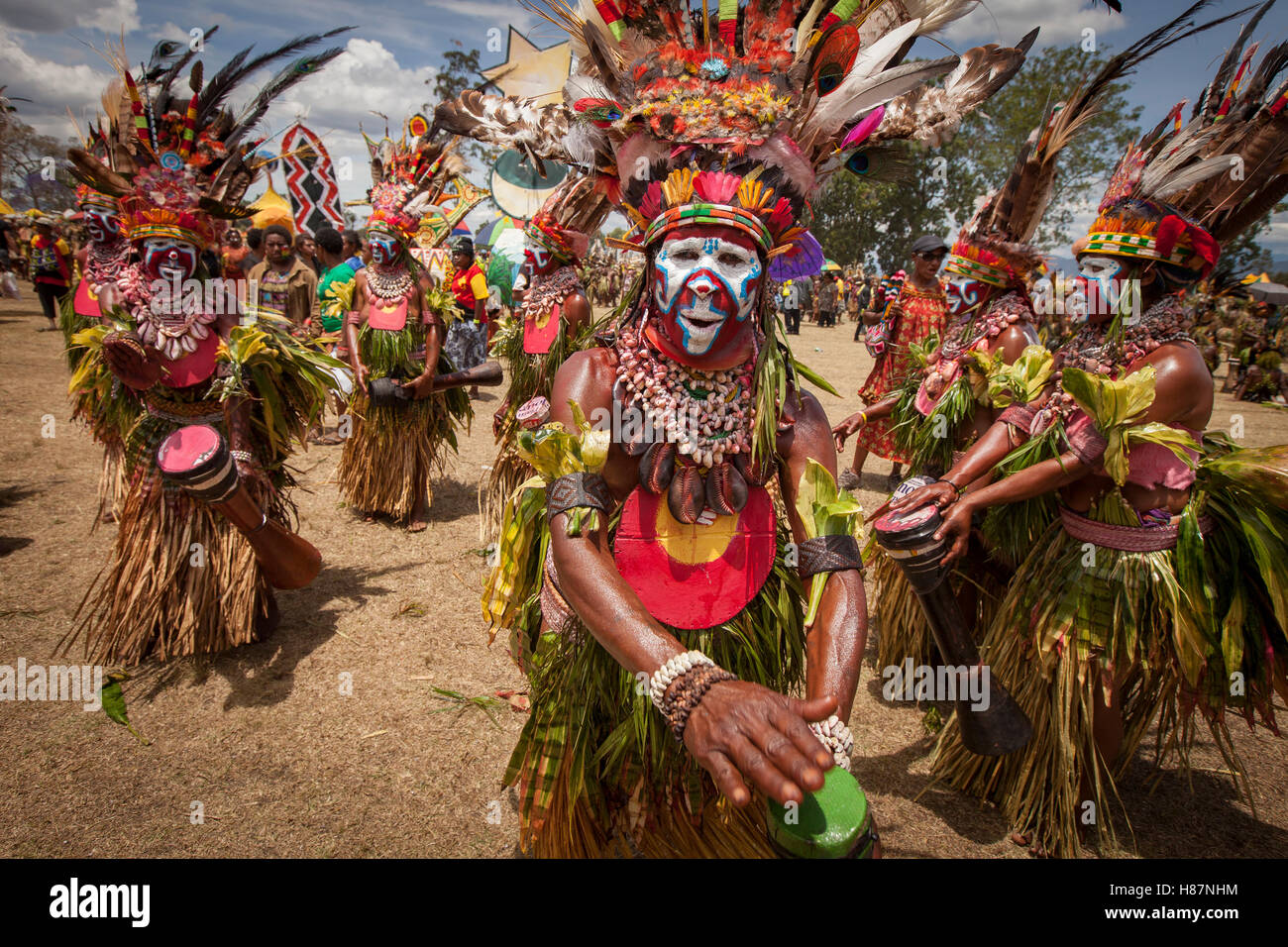 Men in ritual make-up and traditional clothing dancing during a sing ...