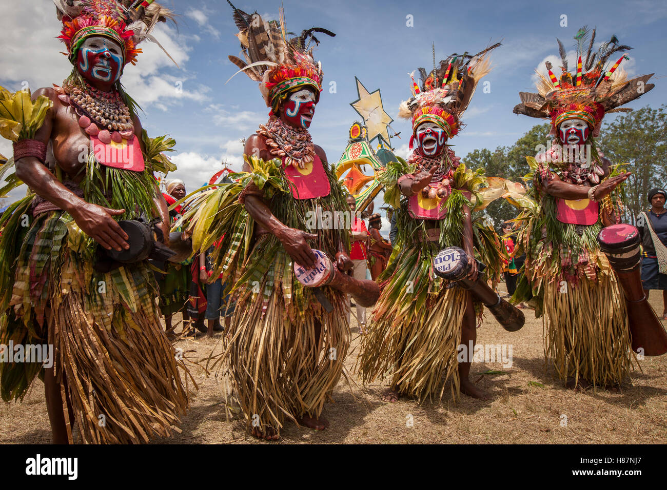 Women in ritual make-up and traditional clothing dancing during a sing ...