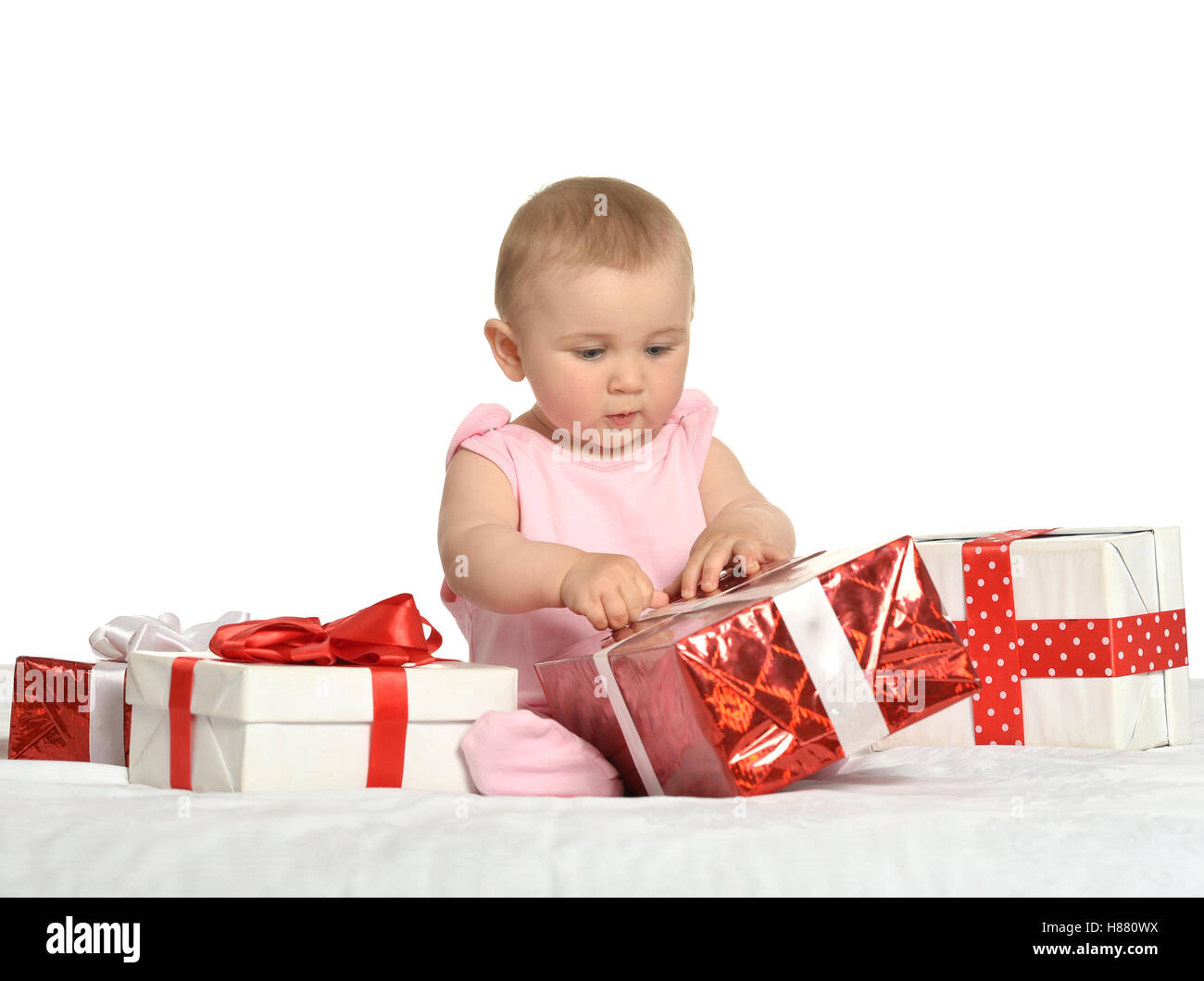 Baby girl sitting with gifts Stock Photo - Alamy