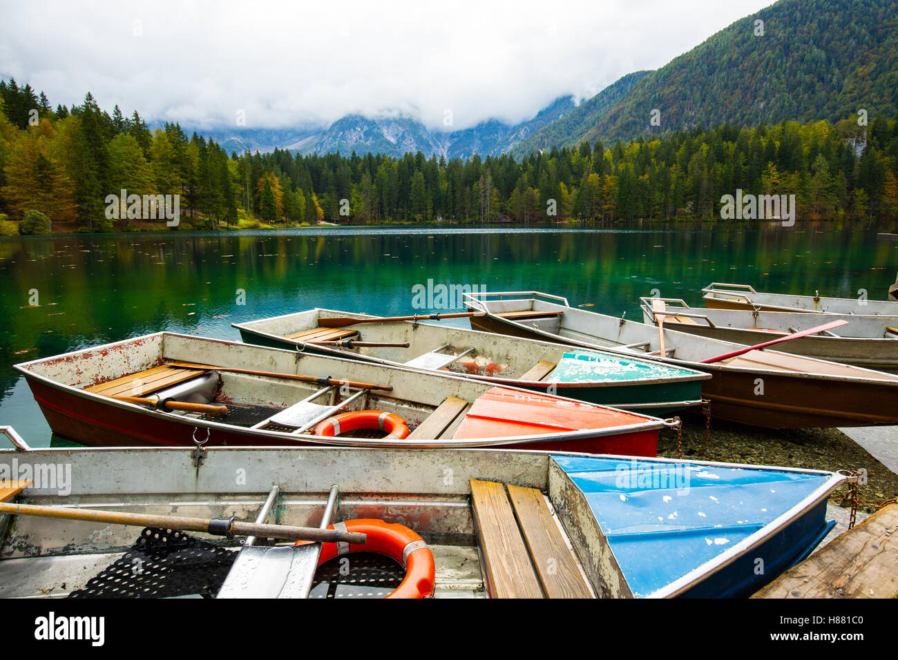 Alpine landscape and colorful boats near Slovenian-Italy border, Lake ...