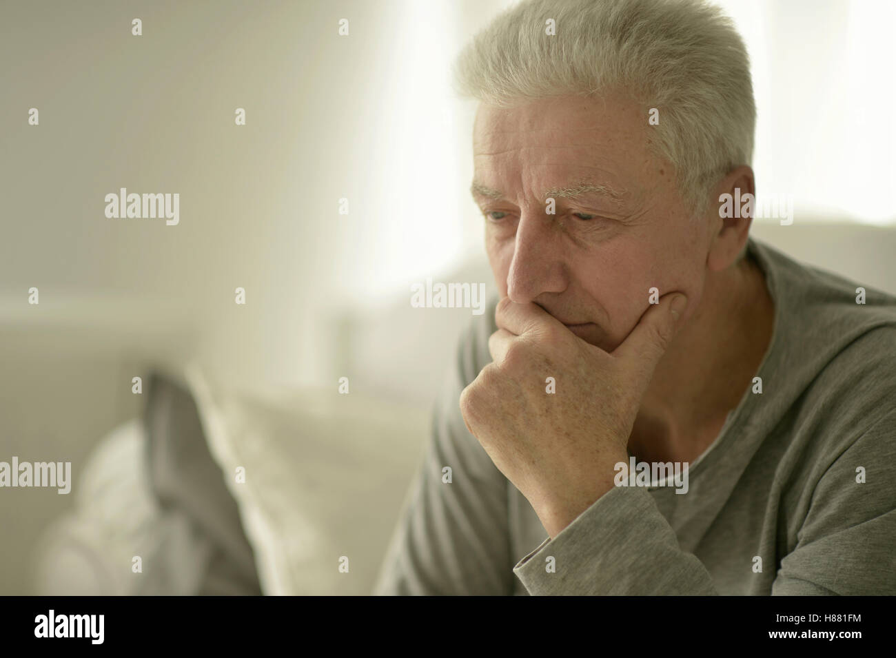 Sad senior man at home Stock Photo - Alamy