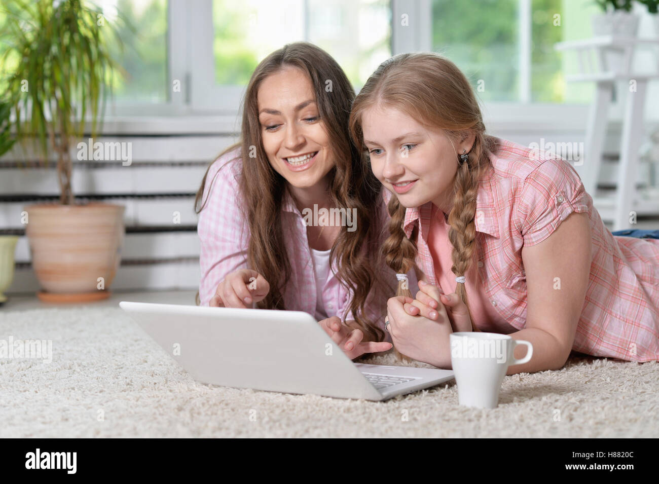 mother and daughter with laptop Stock Photo - Alamy