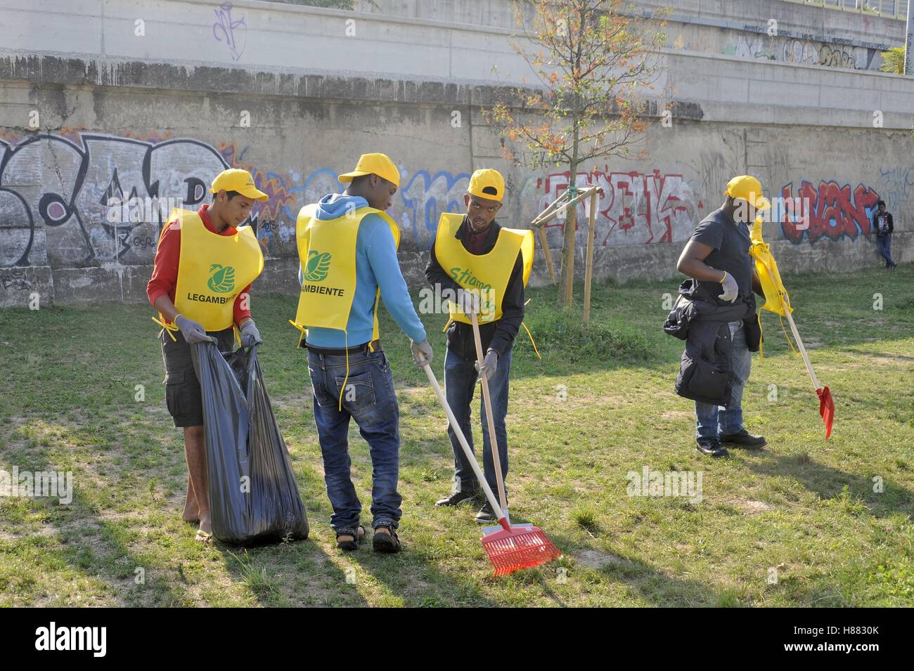 Milan, (Italy), a group of refugees and asylum seekers clean up the ...