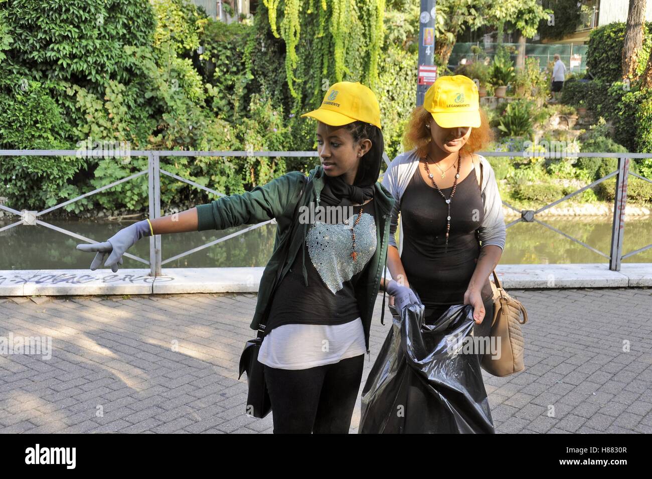 Milan, (Italy), a group of refugees and asylum seekers clean up the ...