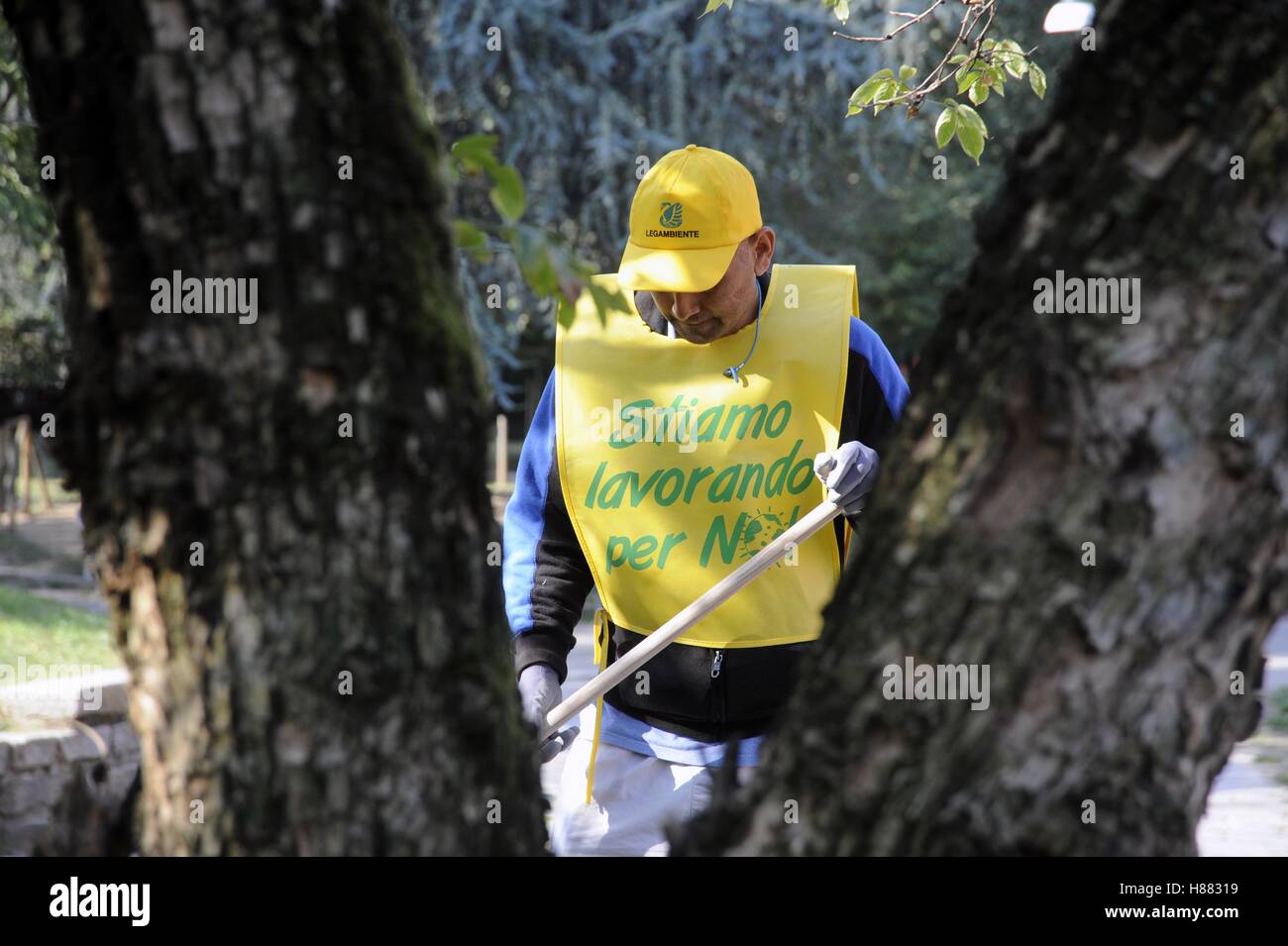 Milan, (Italy), a group of refugees and asylum seekers clean up the ...