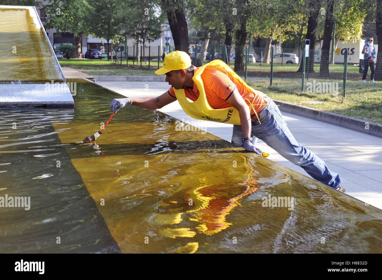 Milan, (Italy), a group of refugees and asylum seekers clean up the ...