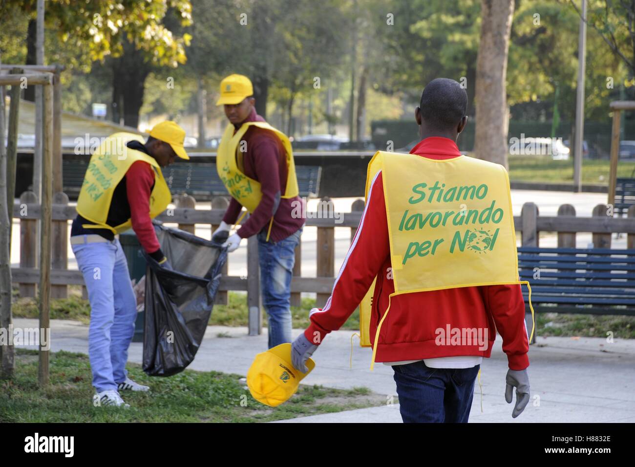 Milan, (Italy), a group of refugees and asylum seekers clean up the ...