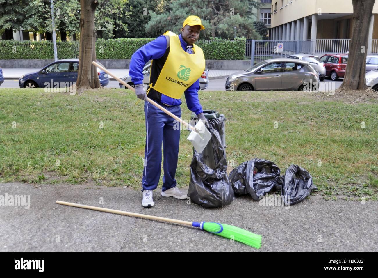 Milan, (Italy), a group of refugees and asylum seekers clean up the ...