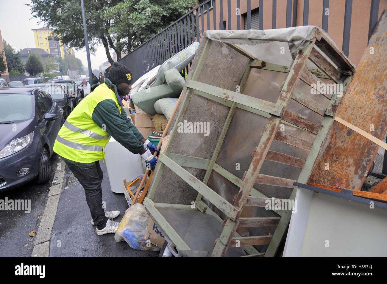 Milan, (Italy), a group of refugees and asylum seekers clean up ...