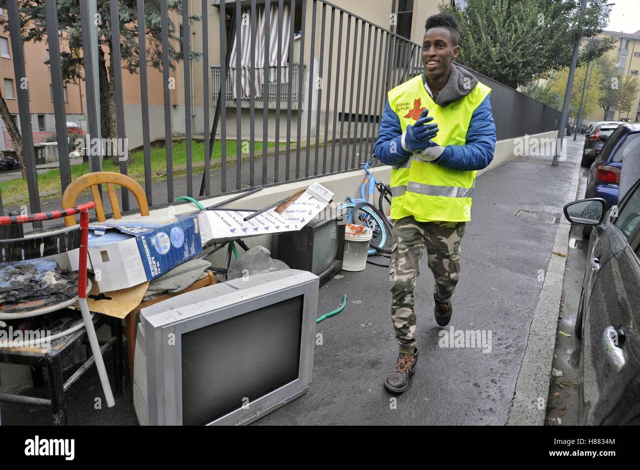 Milan, (Italy), a group of refugees and asylum seekers clean up ...