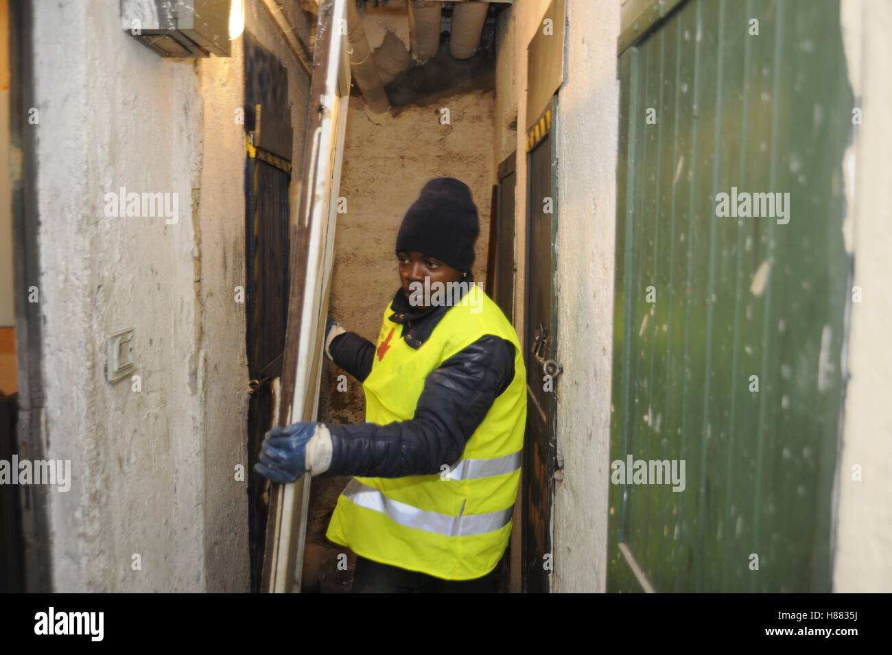 Milan, (Italy), a group of refugees and asylum seekers clean up ...