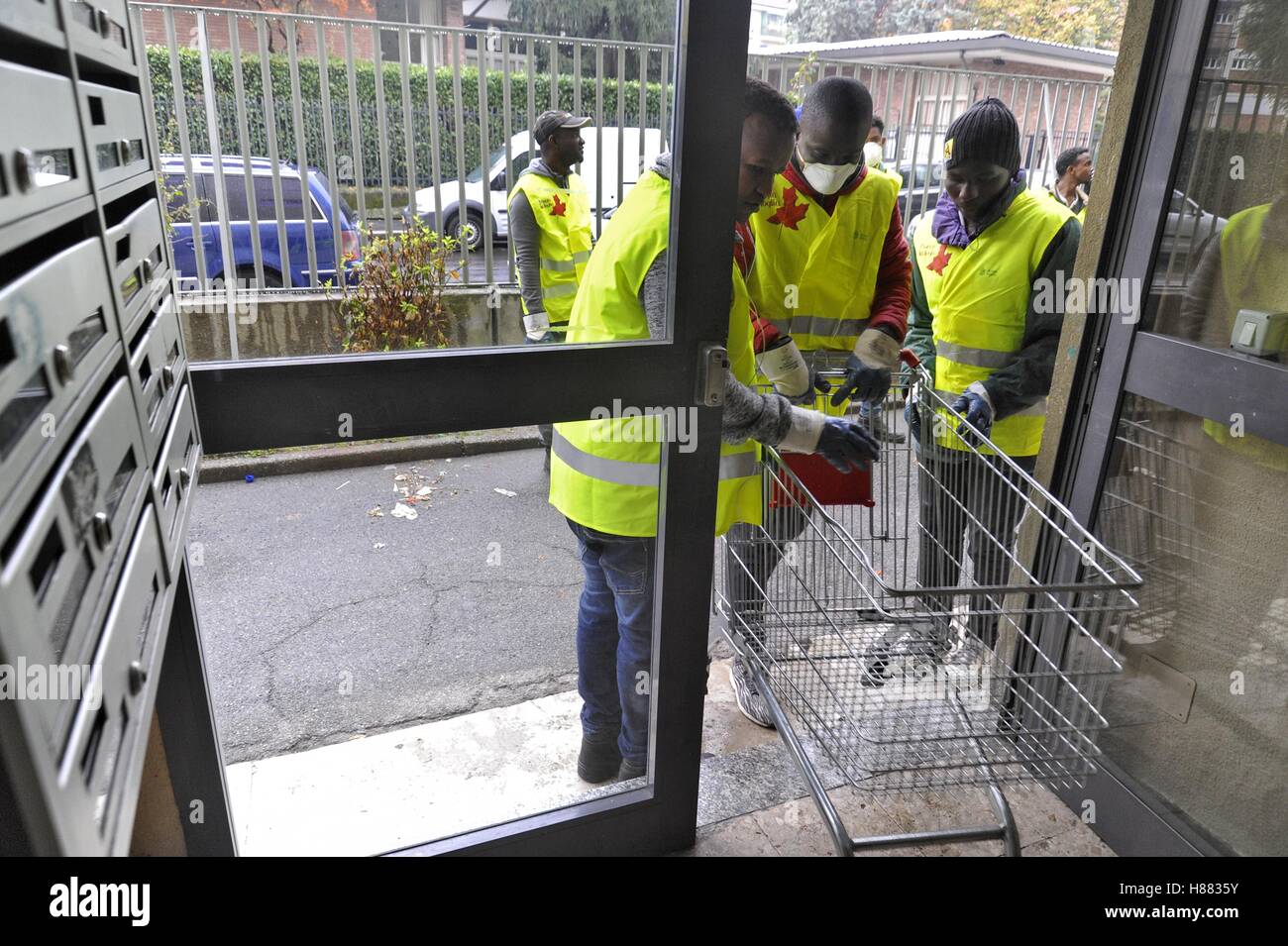 Milan, (Italy), a group of refugees and asylum seekers clean up ...