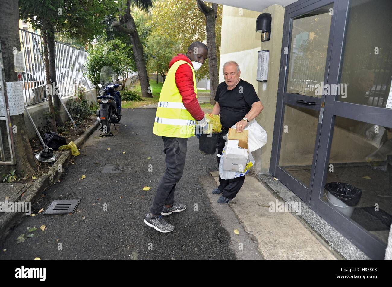 Milan, (Italy), a group of refugees and asylum seekers clean up ...