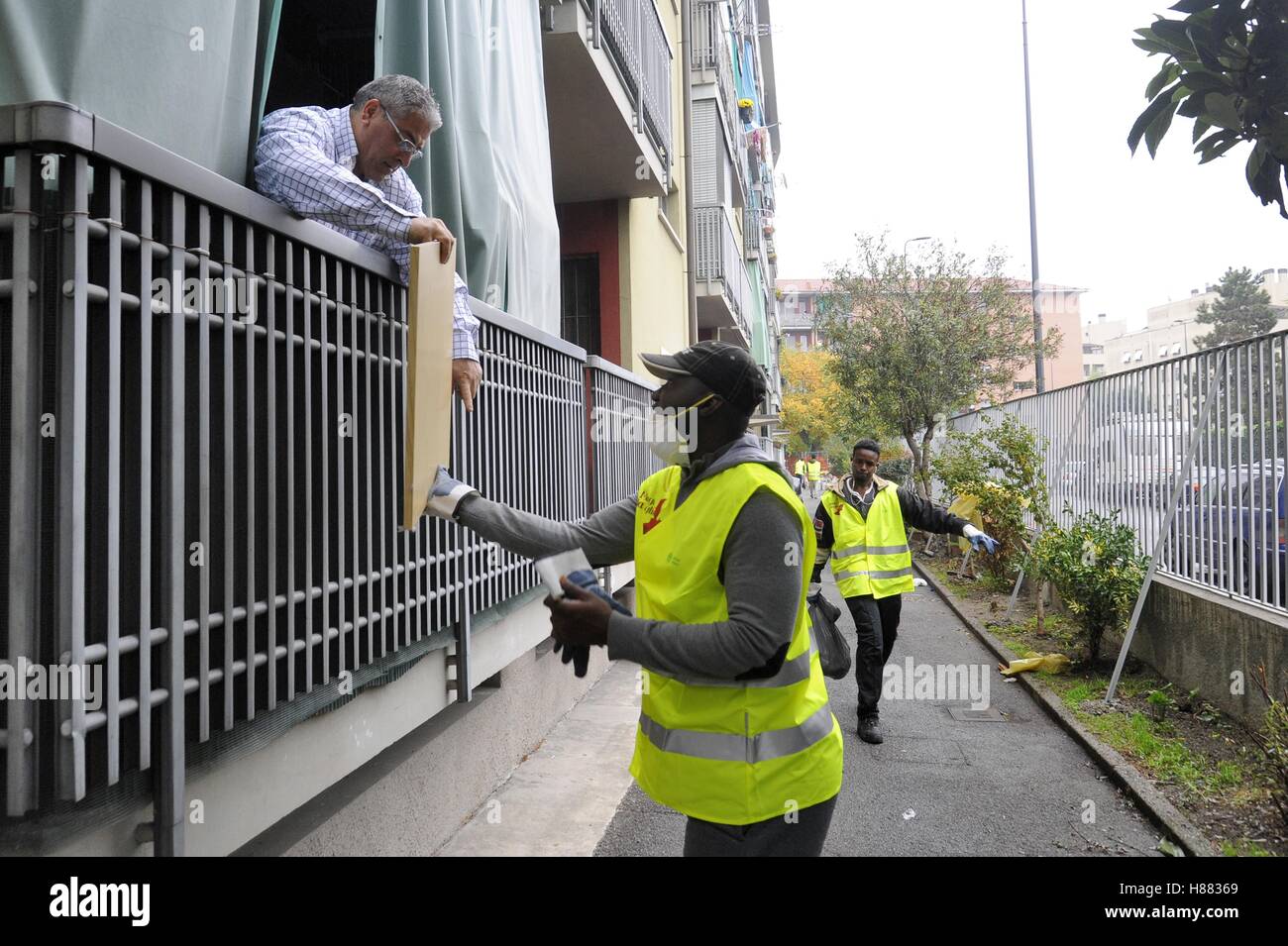 Milan, (Italy), a group of refugees and asylum seekers clean up ...