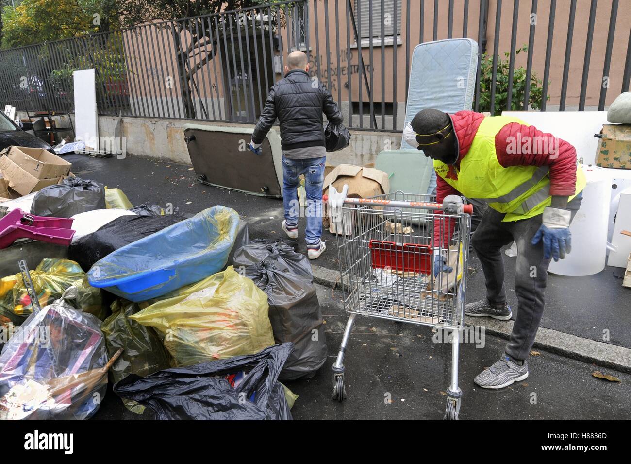 Milan, (Italy), a group of refugees and asylum seekers clean up ...