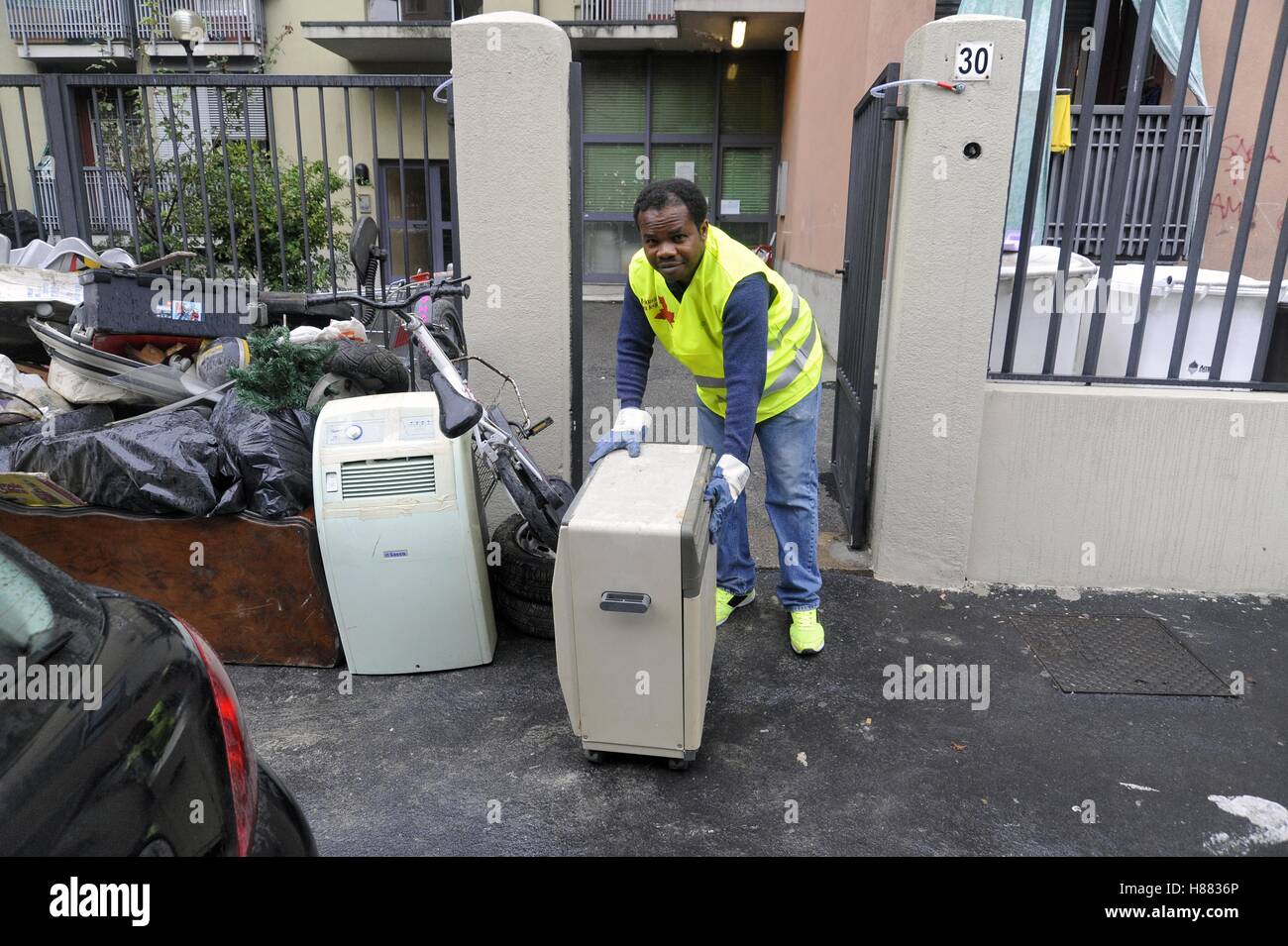 Milan, (Italy), a group of refugees and asylum seekers clean up ...