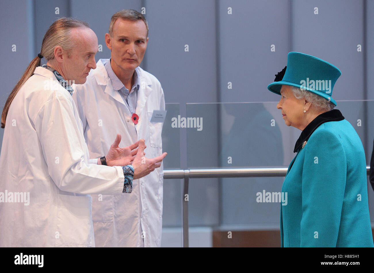 Queen Elizabeth II, talks with senior scientists Aengus Stewart (left ...