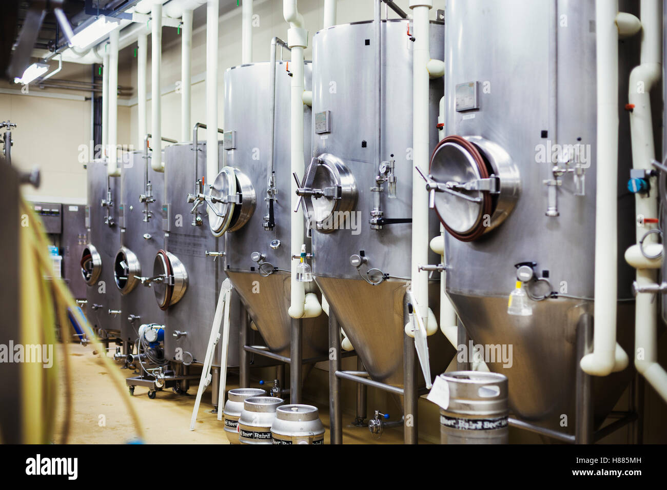 Row of large metal beer tanks in a brewery Stock Photo - Alamy