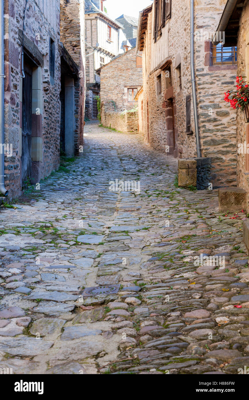 A cobbled alleyway in Conques (France). That medieval village shows ...