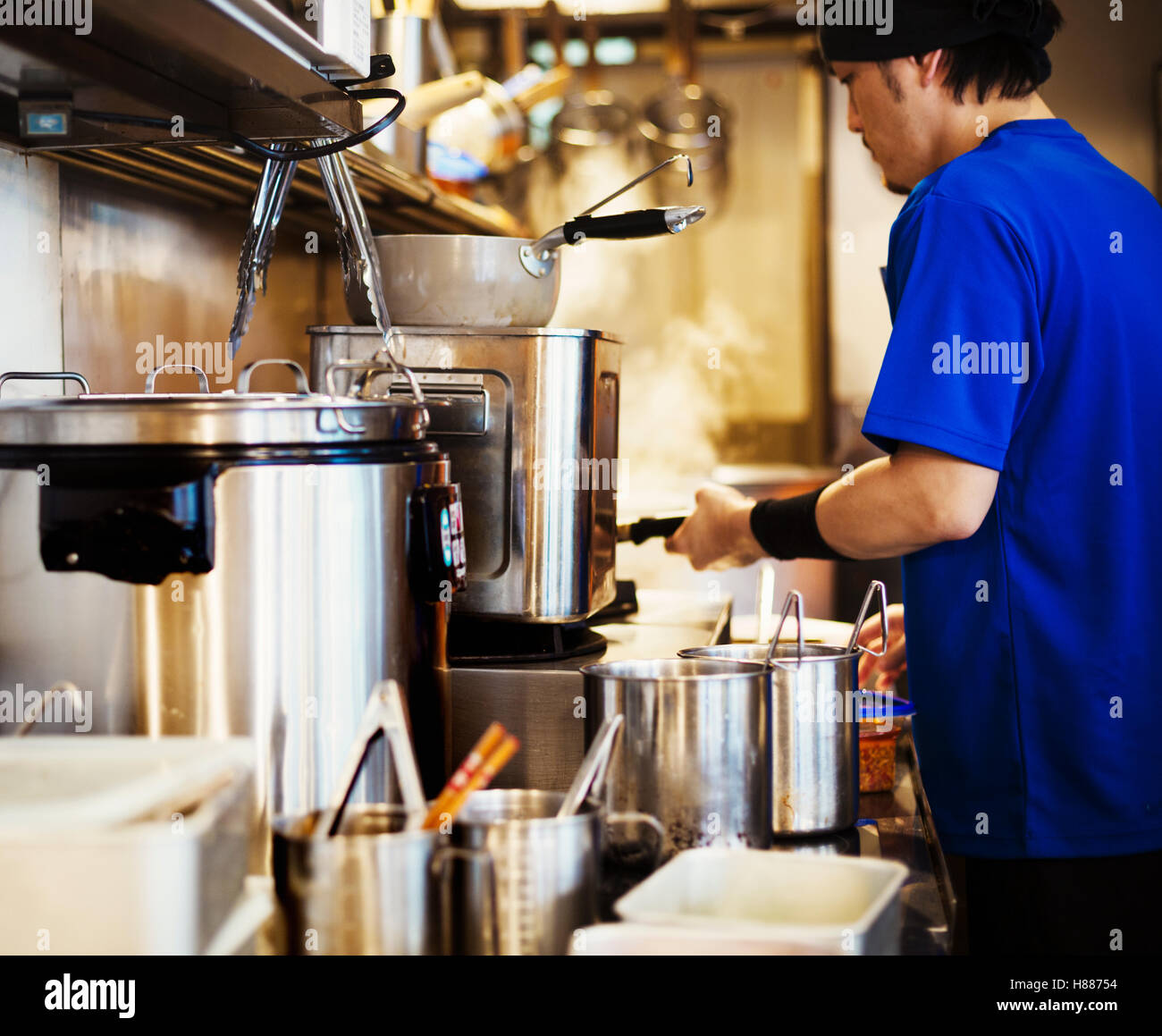 The ramen noodle shop. A chef working in a kitchen Stock Photo - Alamy