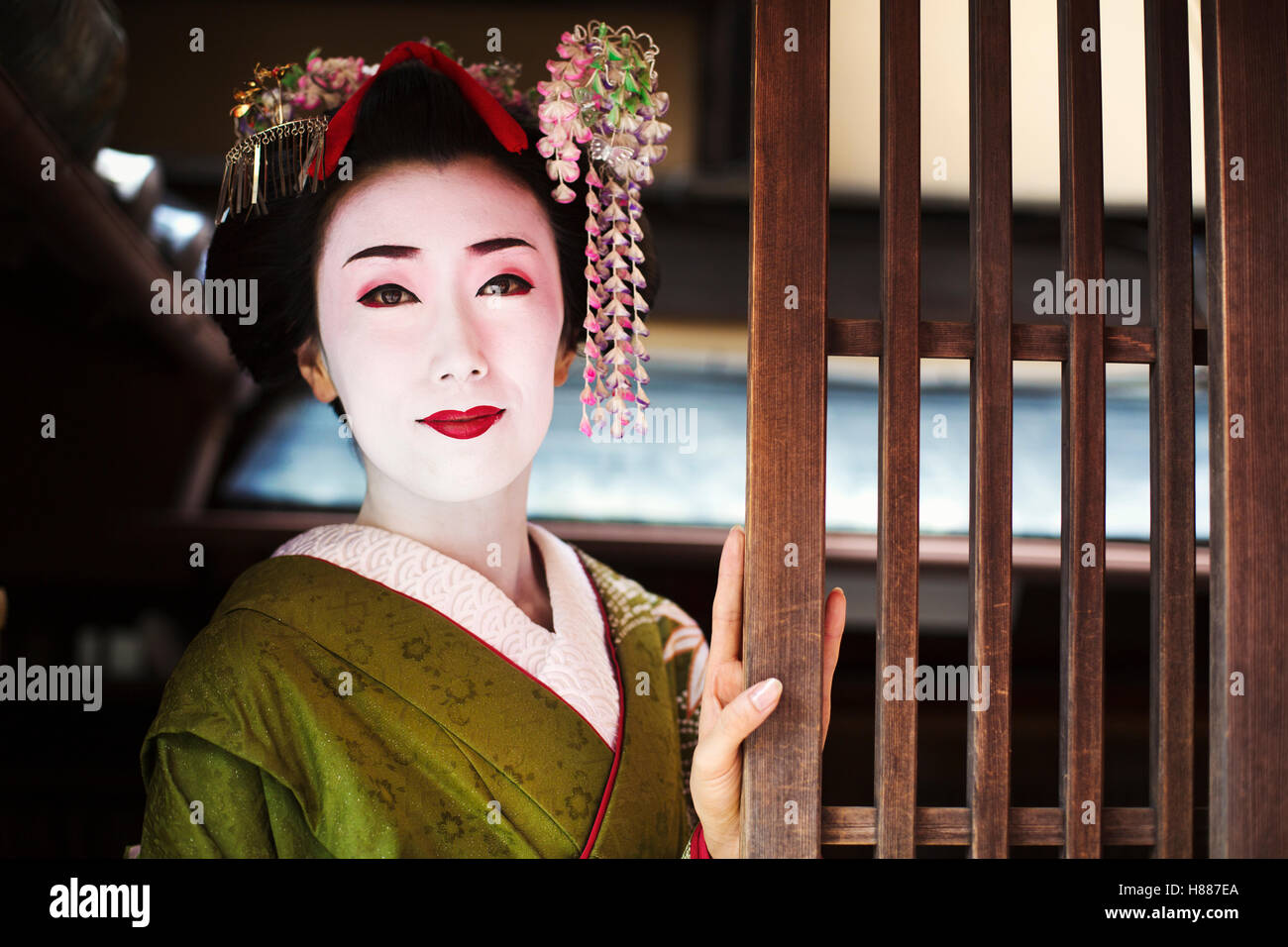 A woman dressed in the traditional geisha style, wearing a kimono and ...