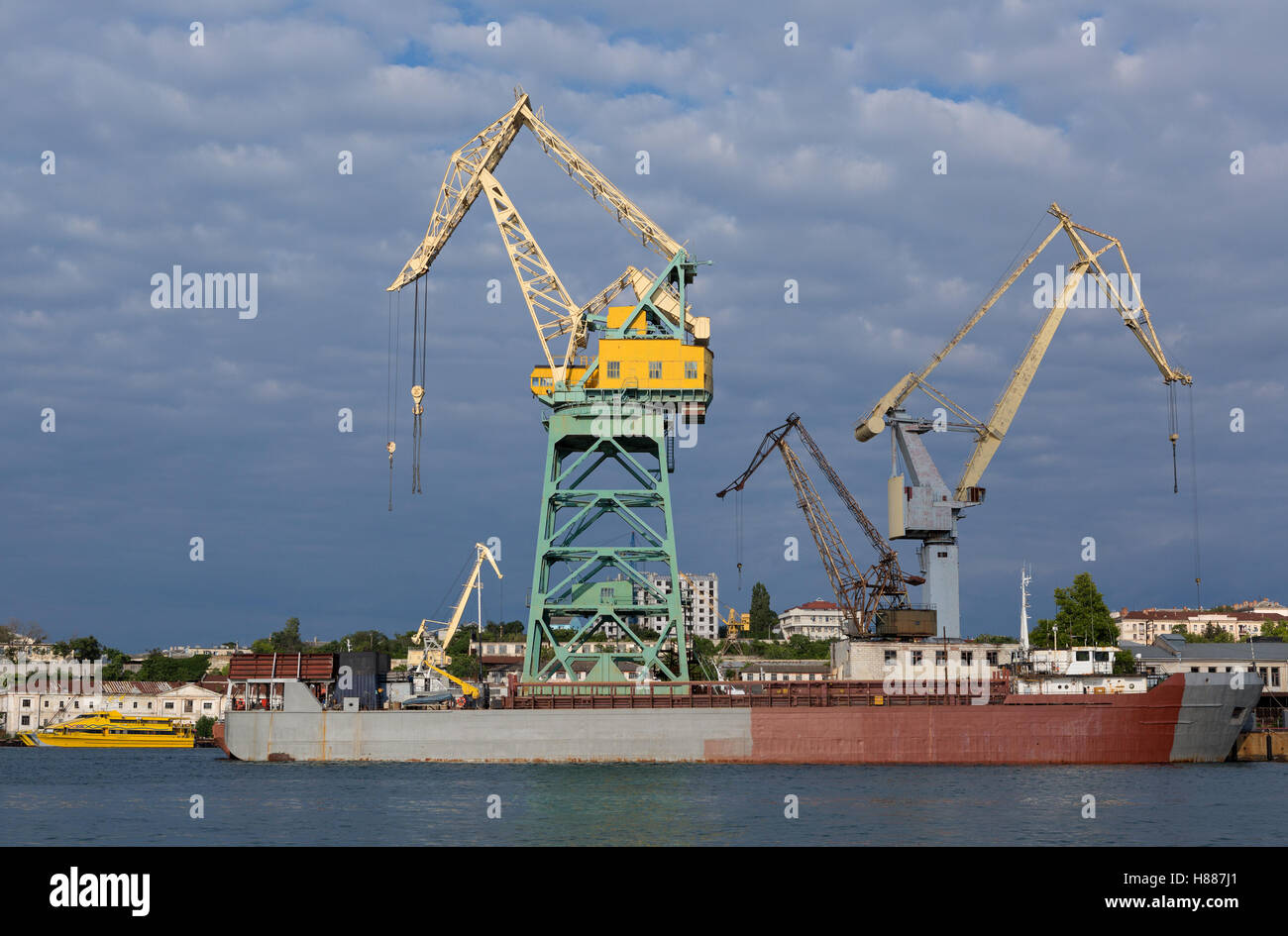 Lifting cargo cranes at the shipyard in Bay of Black Sea Stock Photo ...