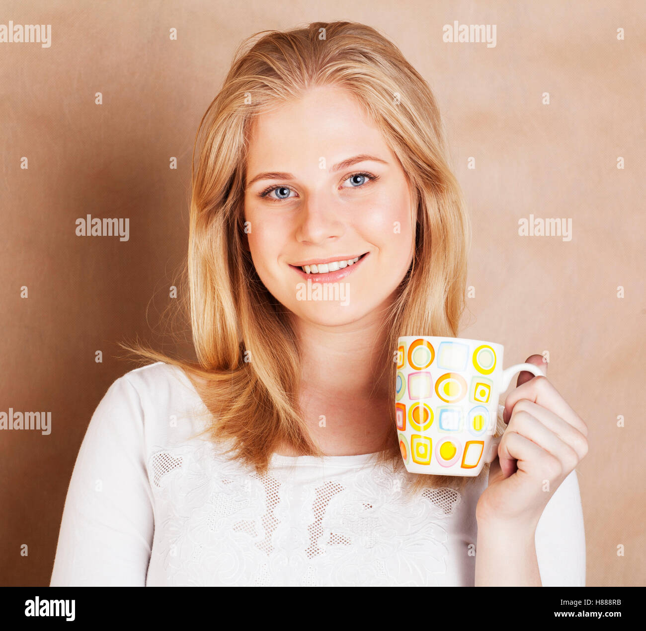 young cute blond girl drinking coffee close up on warm brown bac Stock ...