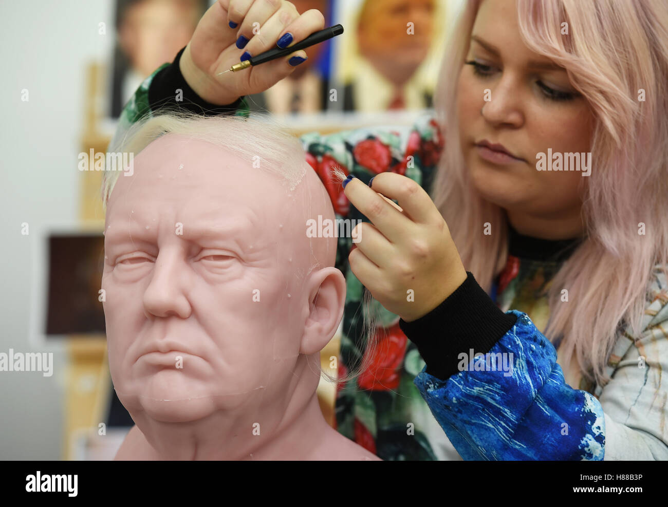Sophie Crudgington inserts Yak hairs onto an unfinished wax figure of ...