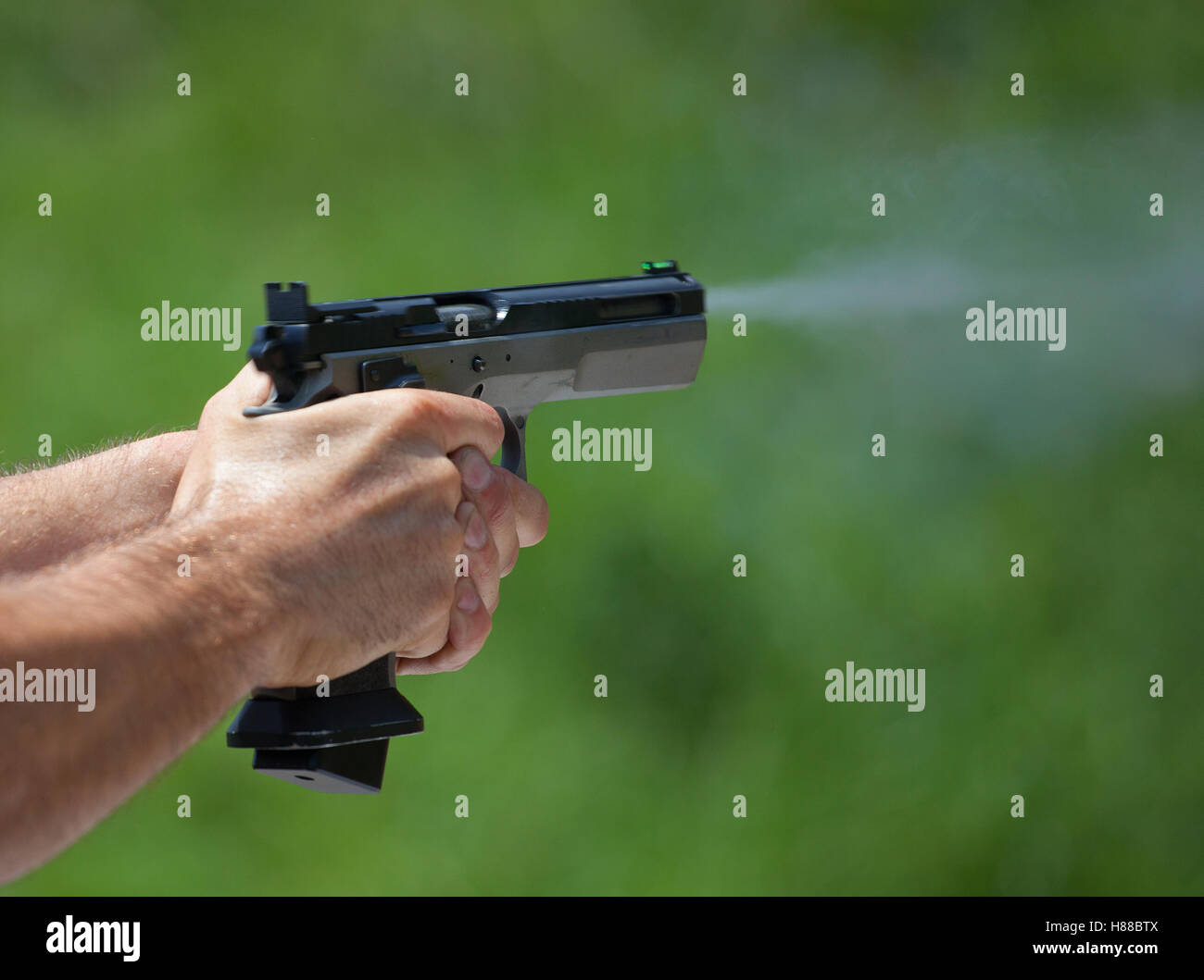 Handgun with smoke the moment a bullet has been launched Stock Photo ...