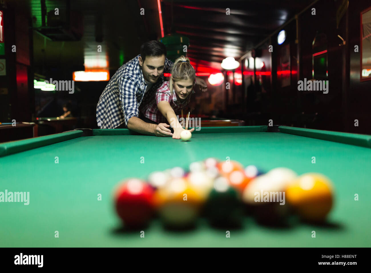 Couple dating and having fun playing snooker Stock Photo - Alamy